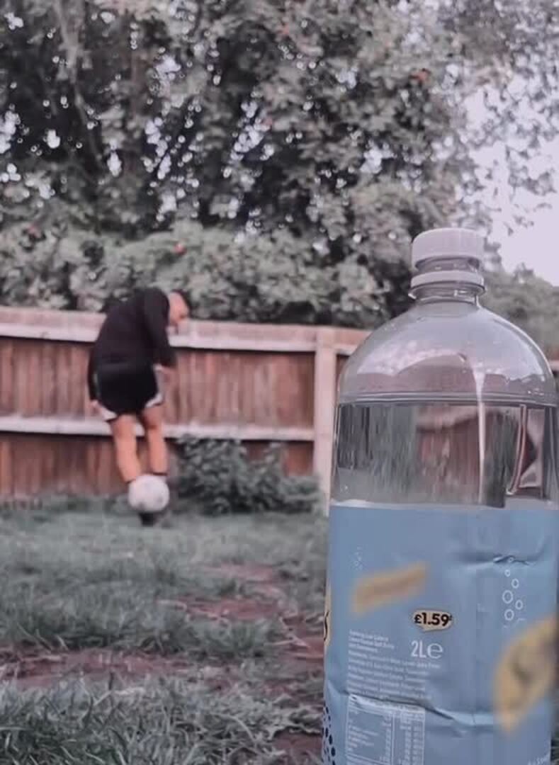 Person Uses Football to Perform Bottle Cap Trickshot | Jukin Licensing