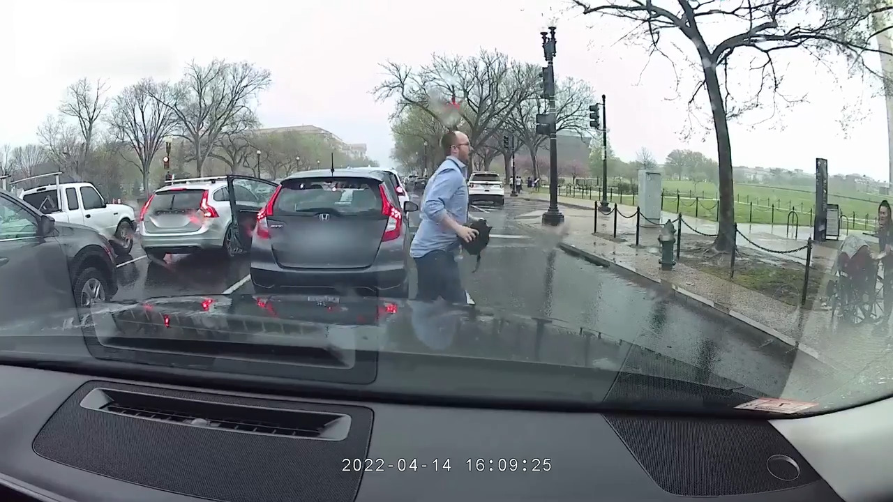 Man Jumps Out of Car to Give Strangers an Umbrella | Jukin Licensing