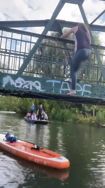 Woman Does Risky Paddleboard Bridge Jump | Jukin Licensing