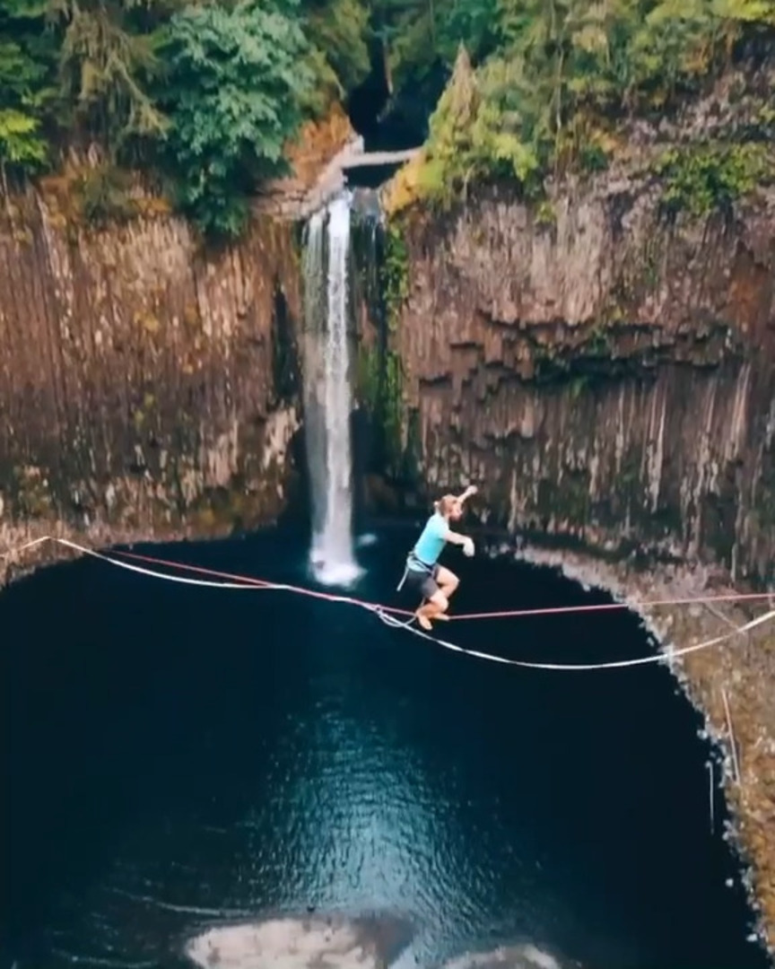 Guy Goes Slacklining Between Two Cliffs in Forest | Jukin Licensing