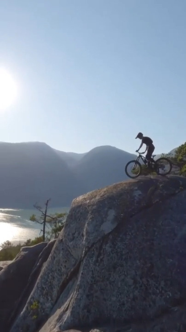 Cyclist Climbs Down Steep Hill Amidst Scenic Landscape | Jukin Licensing