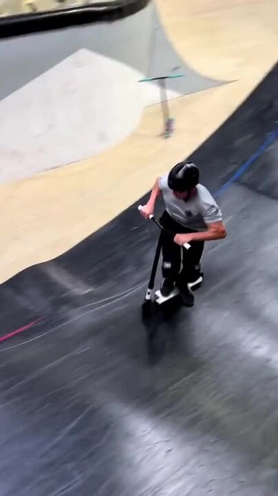 Professional Scooter Rider Attempts Flip Tricks on Skate Park's Ramps ...