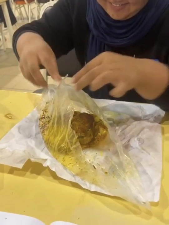 Person Struggles to Unwrap Food Packaging | Jukin Licensing