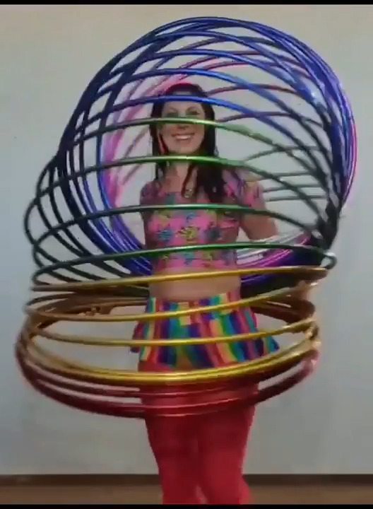 Person Spins Set of Multi-coloured Hula Hoops | Jukin Licensing