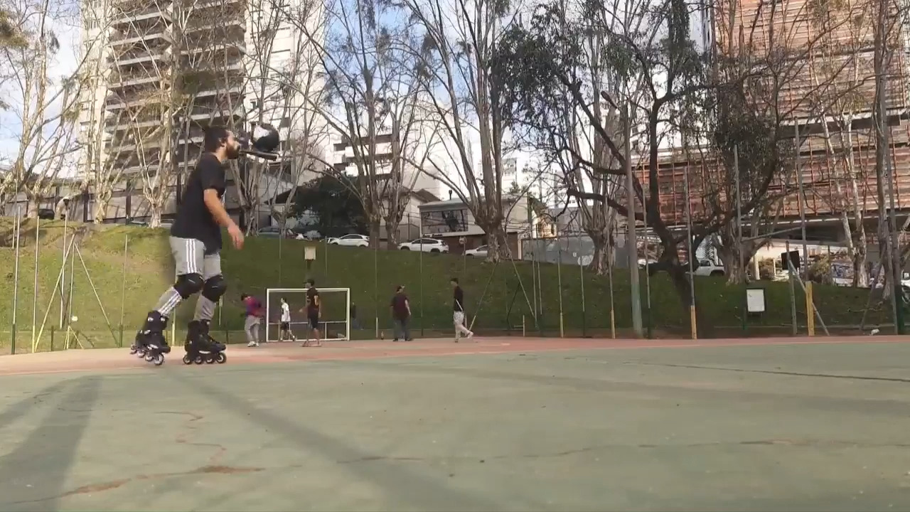 Guy Wearing Rollerblades Balances Ball Over Cone Extending From His ...