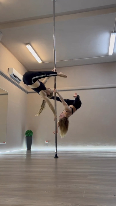 Duo of Women Demonstrate Coordinated Pole Dancing Tricks | Jukin Licensing