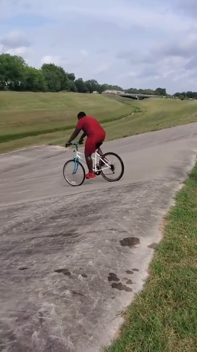 Guy Falls Off Bike While Riding Down Sloped Road | Jukin Licensing