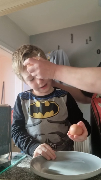 Little Kid Gets Surprised as Mother Breaks Egg by Tapping His Forehead ...