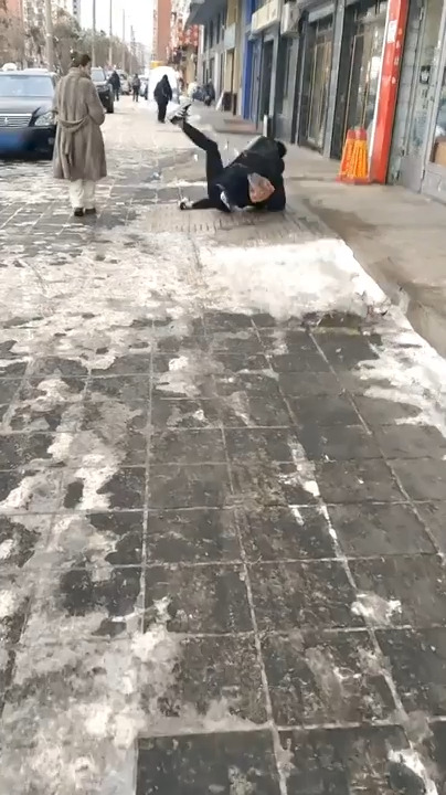 Person Slips and Falls on Icy Sidewalk Slope in Heilongjiang, China ...
