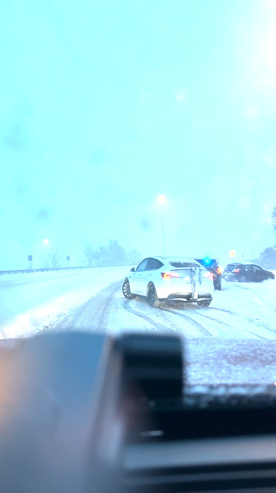 White Car Slides Sideways on Snow Covered Road | Jukin Licensing