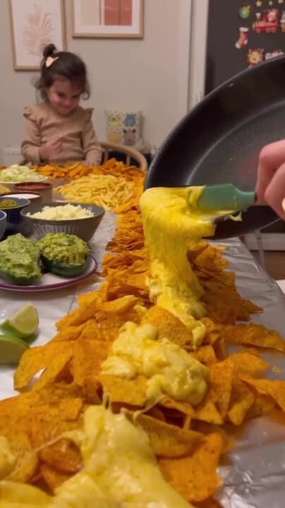 Girls Prepare Cheesy Nachos Recipe on Table | Jukin Licensing