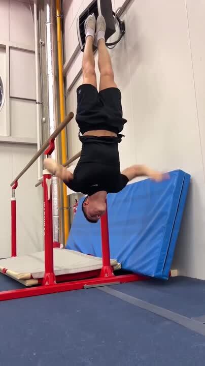 Guy Hangs Upside Down on Parallel Bars and Does Unique Handstand Jump ...