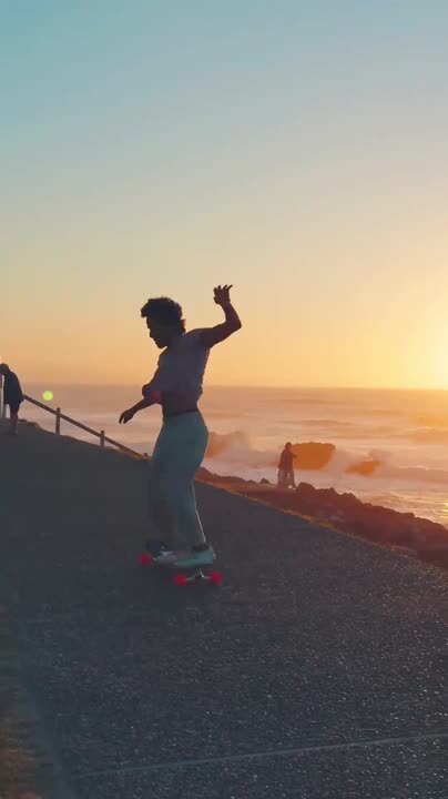 Guy Performs Tricks on Longboard During Sunset at Beach | Jukin Licensing