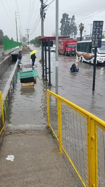 Woman Crossing Flooded Street to Catch Bus Loses Footing and Falls Into ...