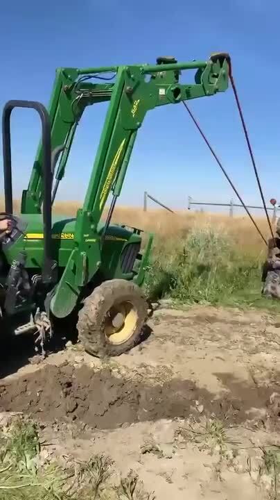 Guy Tips Over Along With Tractor While Trying to Pull Another One Out ...