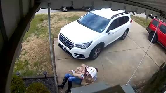Woman Holding Shopping Bags Looses Footing on Porch Steps | Jukin Licensing