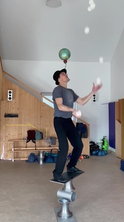 Circus Artist Spins Ball on Hat and Juggles 7 Balls While Balancing on ...