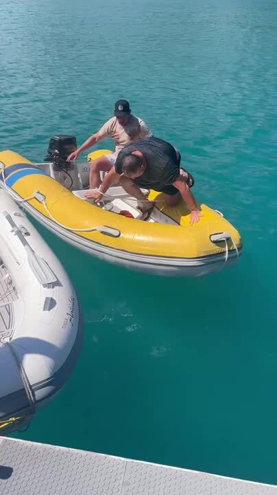 Rescuer Falls Into Water While Rescuing Another Person Into Boat ...