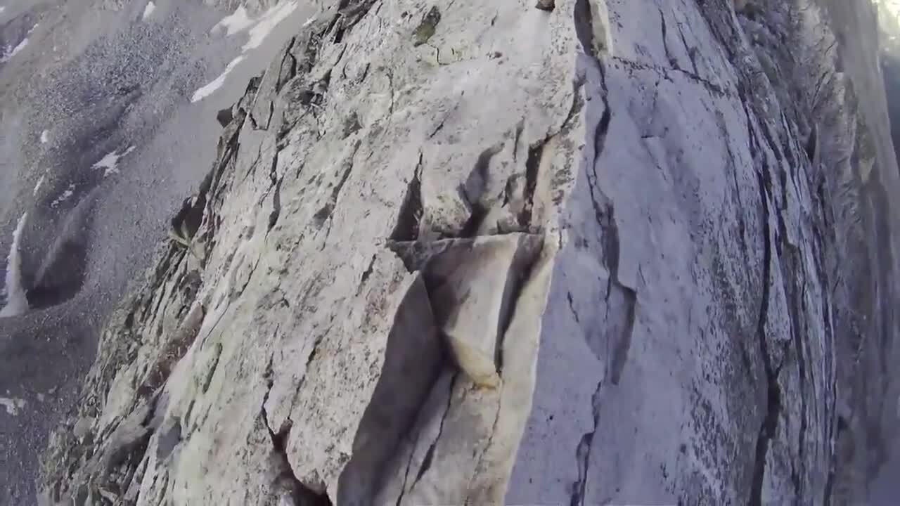 Climbers Walk Along Narrow Mountain Ledge | Jukin Licensing