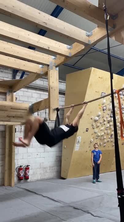Guy Shows Strength by Gripping Wooden Ceiling Plank and Pulling His ...