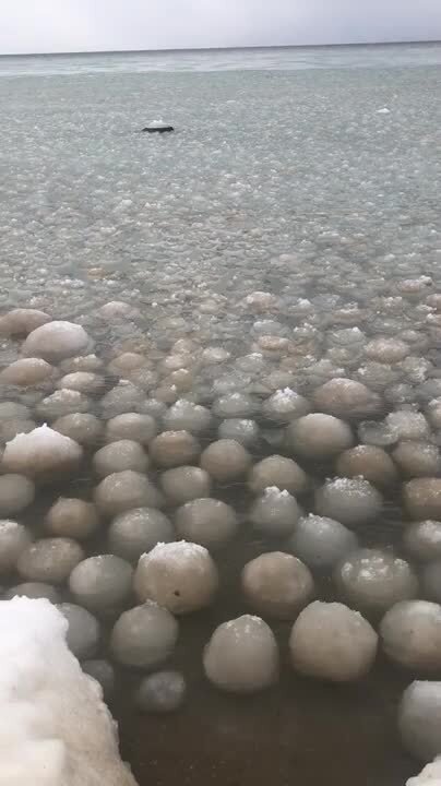 Naturally Formed Ice Spheres Float in Water | Jukin Licensing