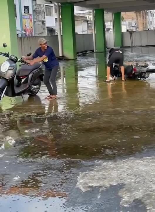 Friends Slip And Fall in Puddle While Struggling to Take Their Scooters ...