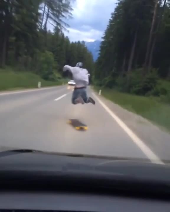 Guy Falls Off Longboard While Long-boarding on Road | Jukin Licensing