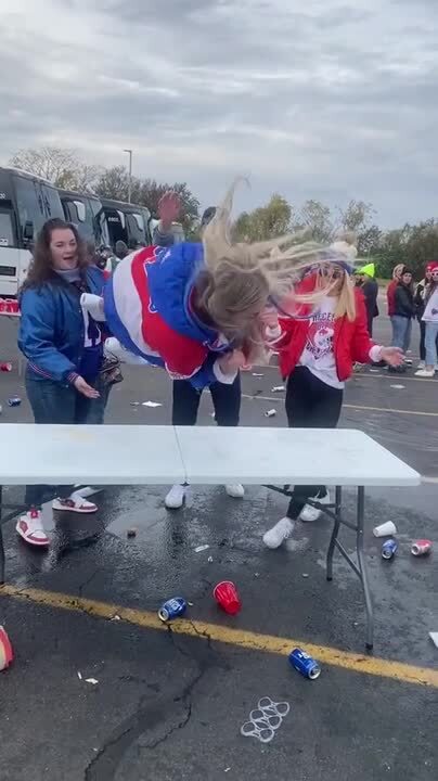 Girl Breaks Table and Falls to Ground After Her Friends Playfully Throw ...