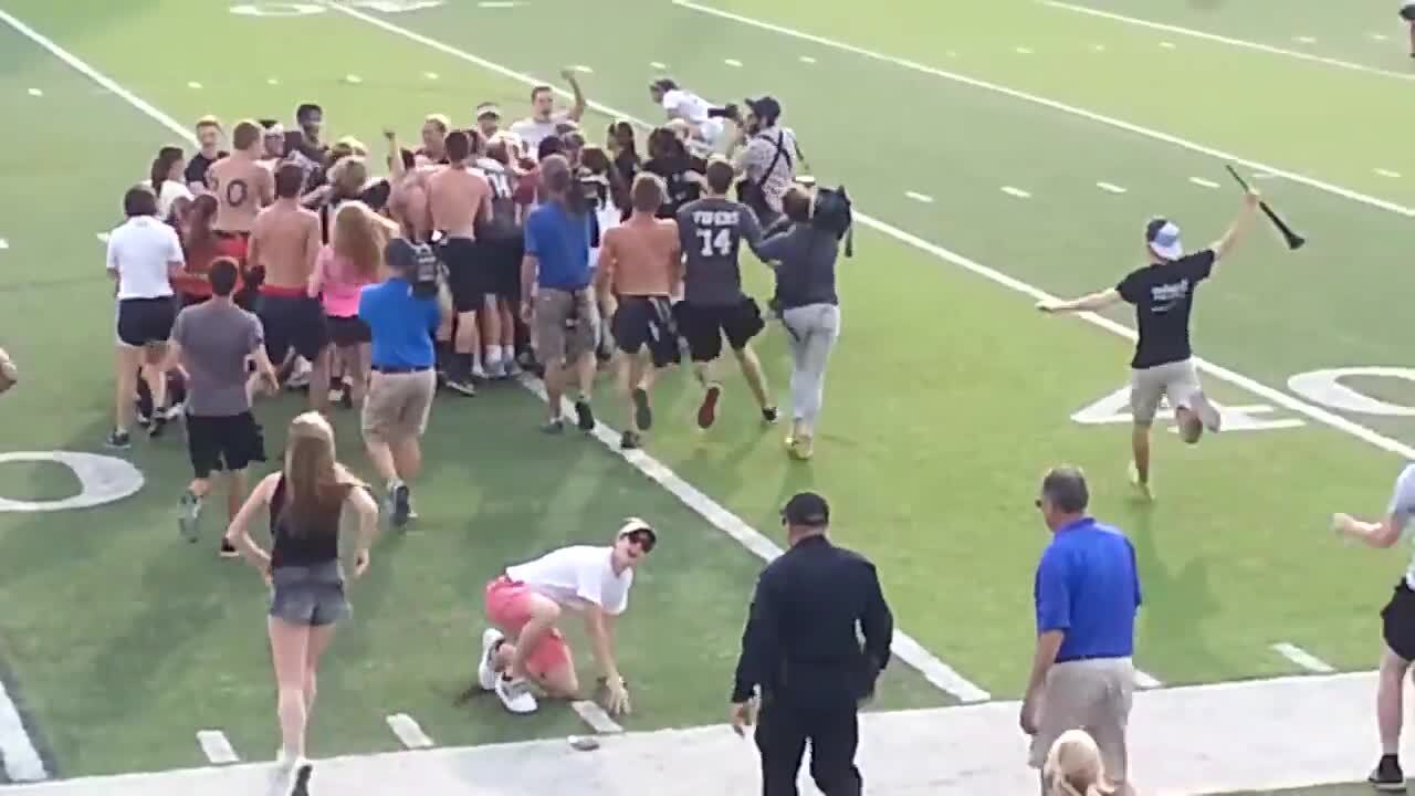 Police Officer Trips and Stops Crowd From Storming Field | Jukin Licensing