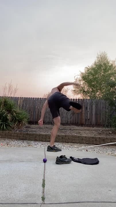 Guy Wears Clothes While Balancing Himself on Slack Line | Jukin Licensing
