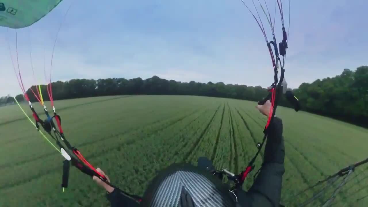Guy Flies Paraglider Close to the Ground and Between Trees in Wide Open ...