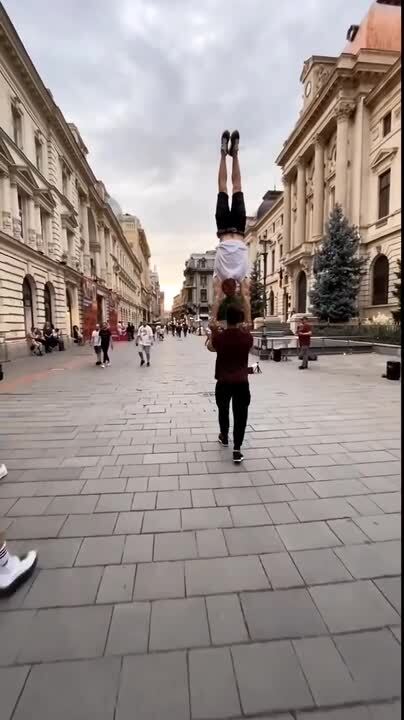 Guy Walks While Balancing Fellow Doing Handstand on His Palms | Jukin ...