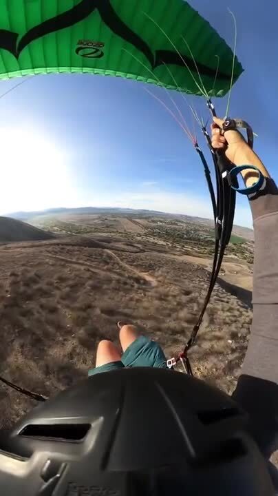Paraglider Flies Close to Surface and Makes Clean Landing | Jukin Licensing