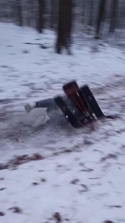 Guy Sledding Downhill Hits Bump in the Snow and Falls to the Ground ...