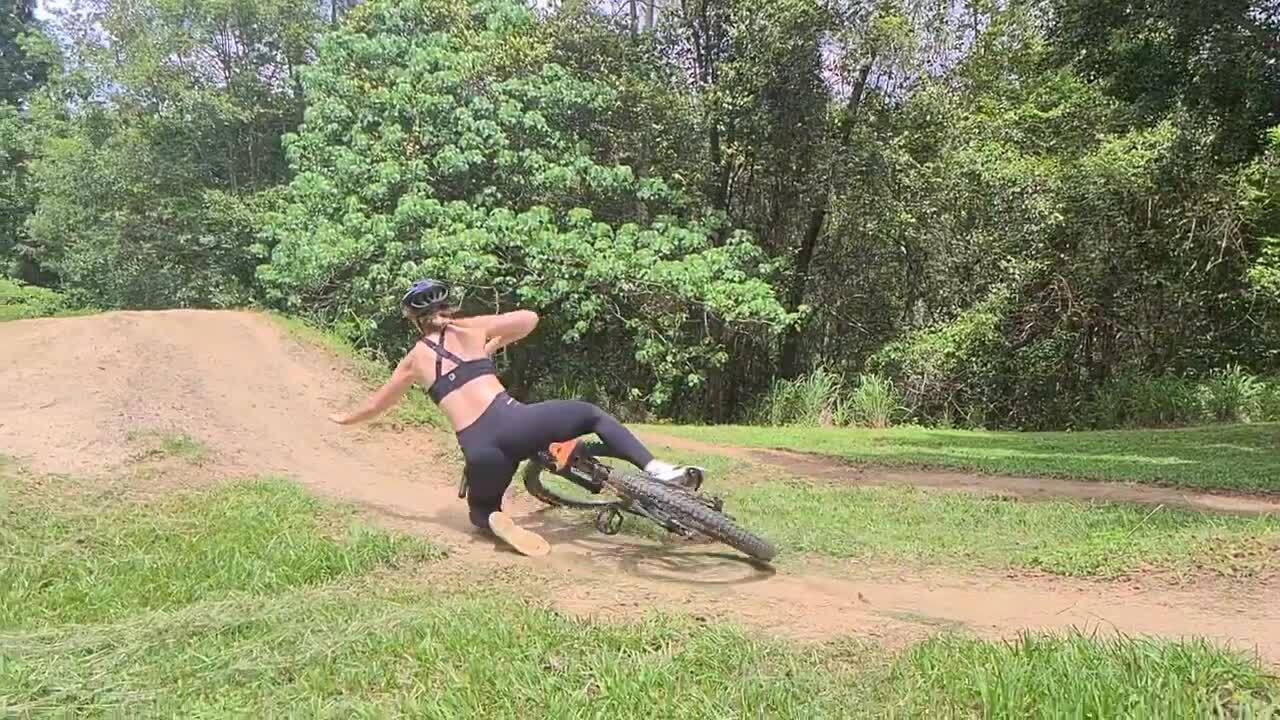 Female Cyclist Falls While Attempting to Jump Over Mud Bump on Her Bike ...