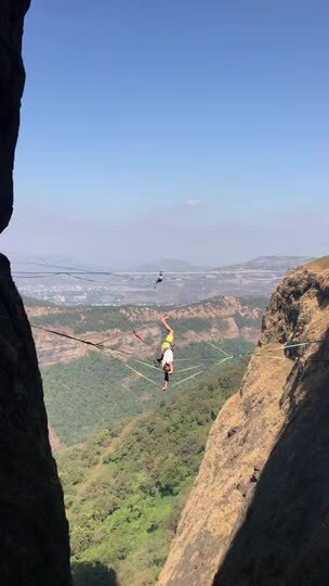 Guy Uses Multiple Cords to Rotate Himself on Slackline Tied Between Two ...