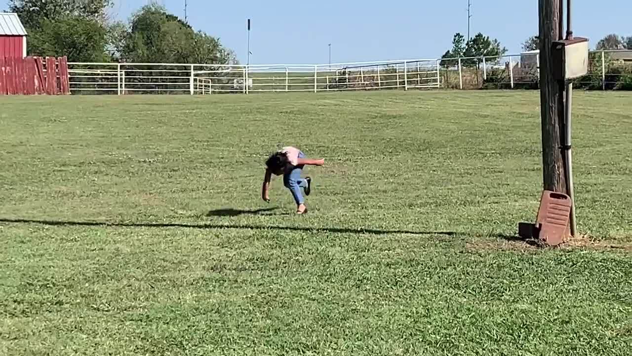Little Girl Rolls on Ground While Attempting to Perform Cartwheel in ...