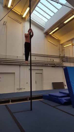 Acrobat Climbs and Spins on Pole | Jukin Licensing
