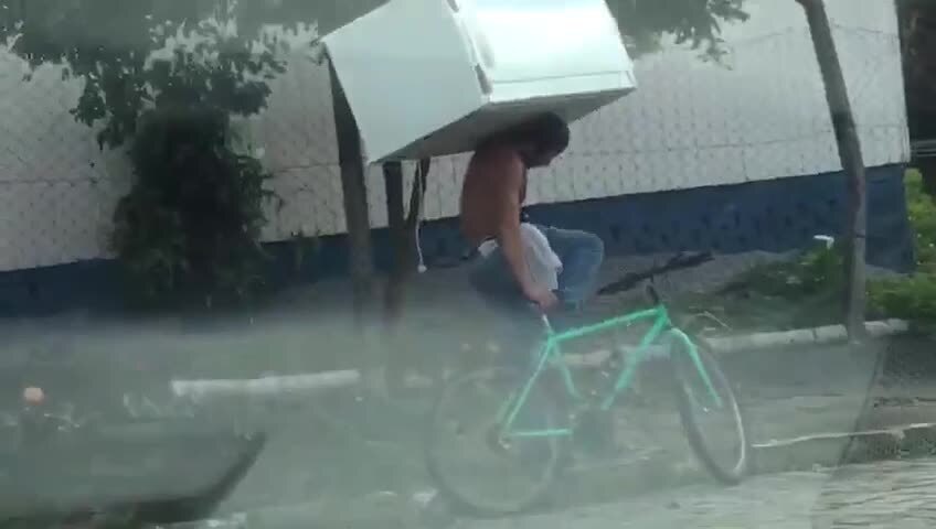 Man Carries Fridge While Riding Bike | Jukin Licensing