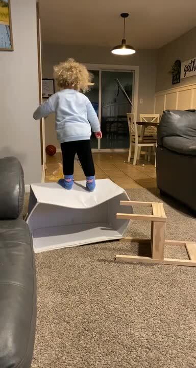Toddler Attempting to Stand Over Box Falls Inside it After it Flips ...