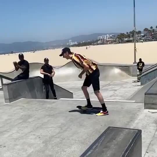 Guy Slides Up Ramp and Holds Skateboard in Hands Momentarily Before ...
