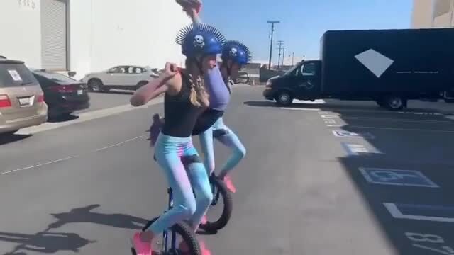 Twins Riding Unicycles Balance Little Sister on Bar | Jukin Licensing