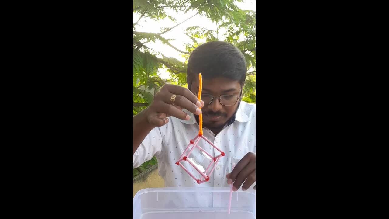 Guy Creates Cube Shaped Bubble in Magnet Stick Cube | Jukin Licensing