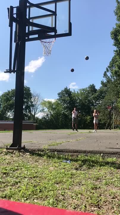 Couple Throws Basketballs in Hoop Together | Jukin Licensing