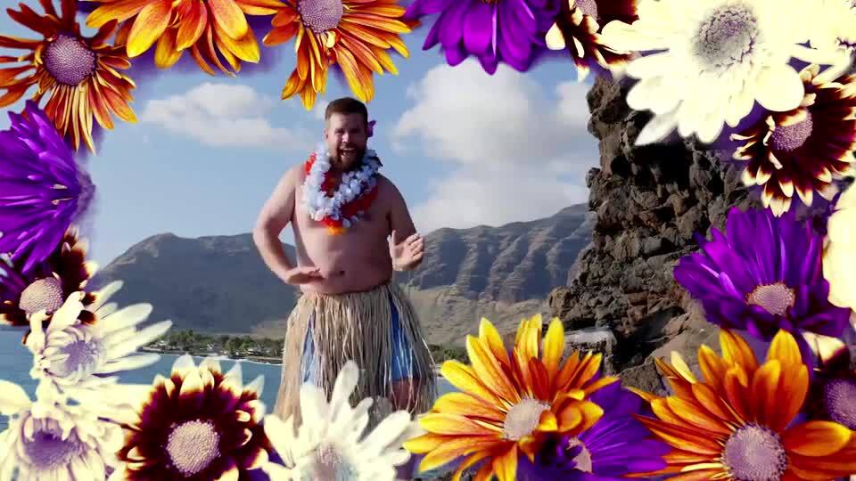 Guy in a lei and hula skirt does the hula dance | Jukin Licensing