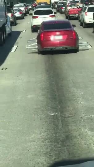 Car With Protruding Wire Rims Drives Down Highway | Jukin Licensing