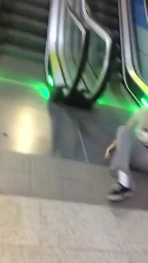 Guy Falls on Neck Attempting to Ride Escalator Railing Lying Down ...
