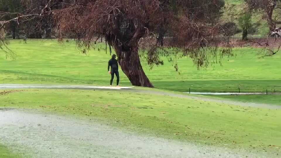 Man Surfs Down Waterlogged Golf Course | Jukin Licensing