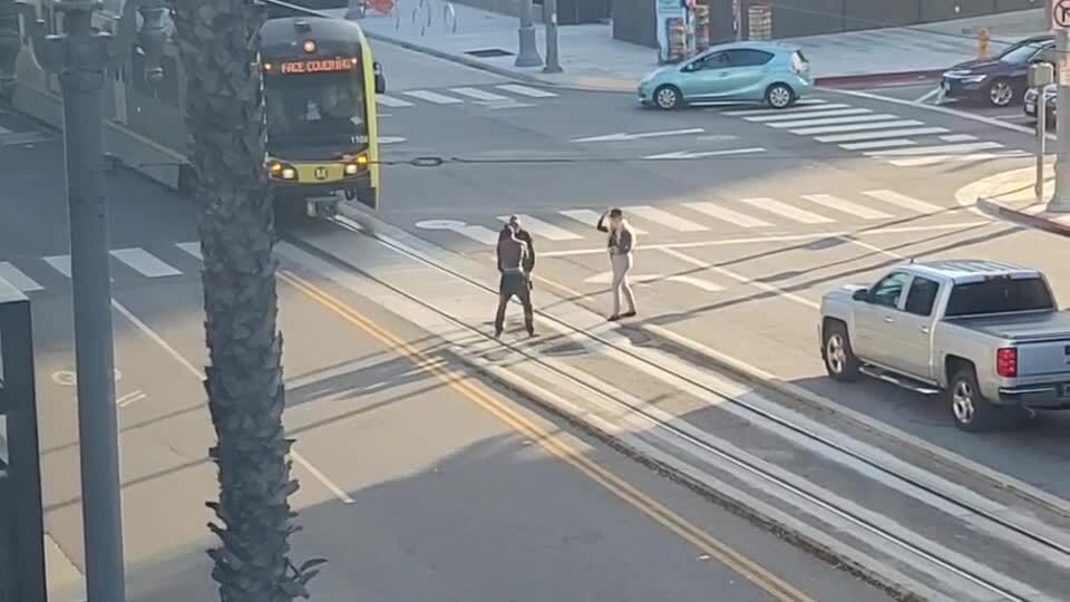 Bystander Hugs Distraught Man Standing on Train Tracks and Gently Pulls ...