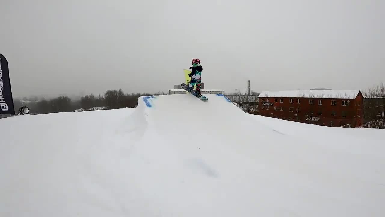 Snowboarder Practices Snowboarding While Jumping Over Springboard From ...